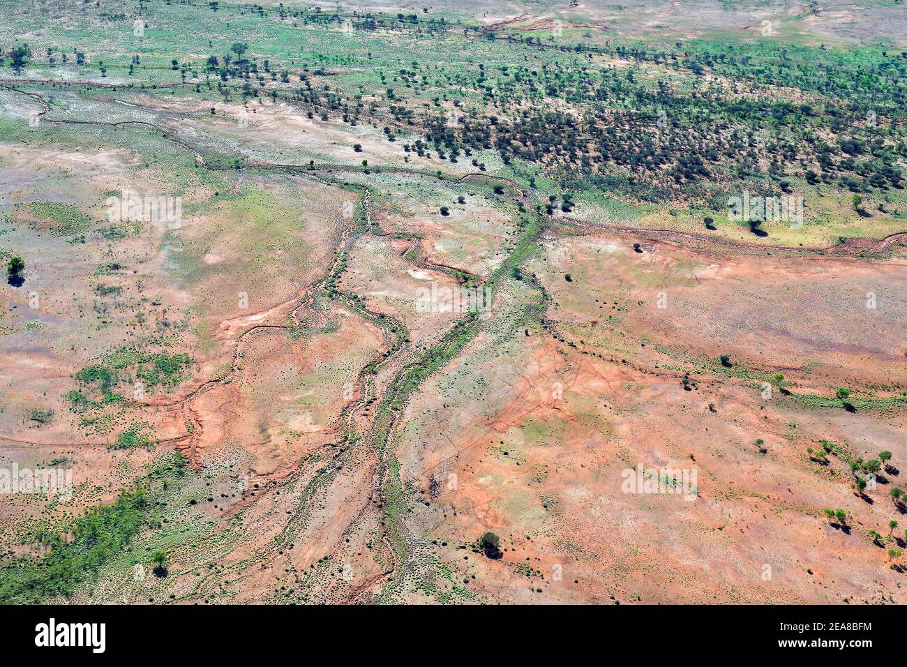 Australia, NT, aerial view over outback landscape with dry river bed ...