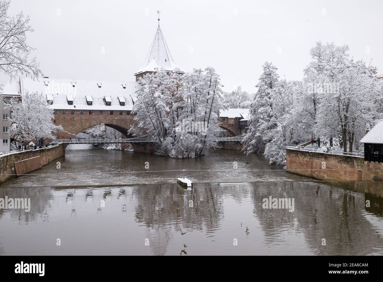 08 February 2021, Bavaria, Nuremberg: Snow covers the Schlayerturm (M ...