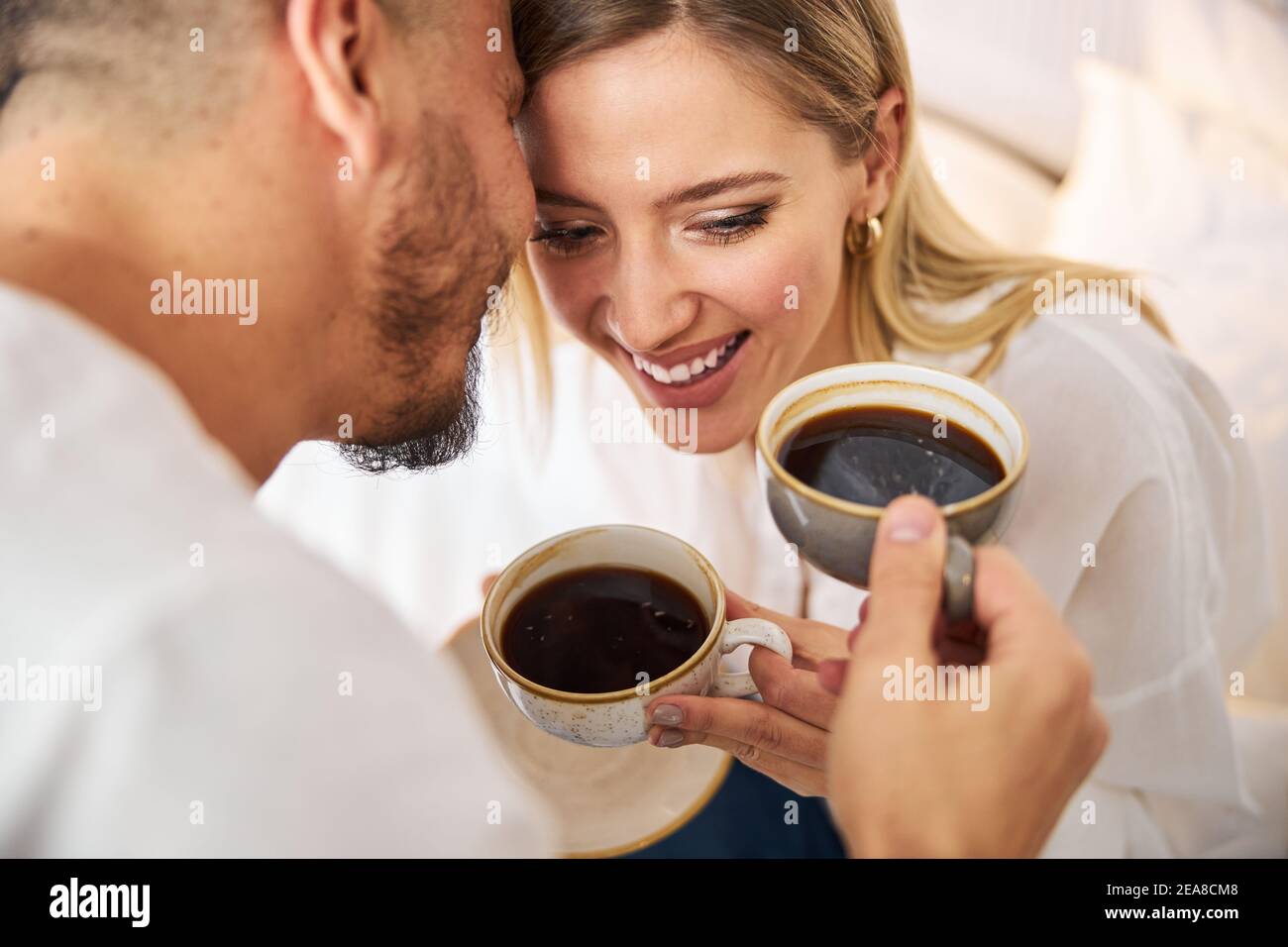 Romantic couple with two cups filled with Americano Stock Photo - Alamy