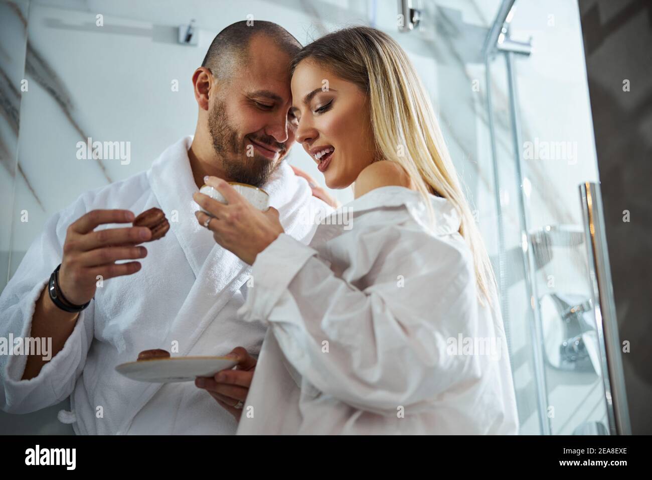 Female treating a man to biscuits and a hot beverage Stock Photo - Alamy