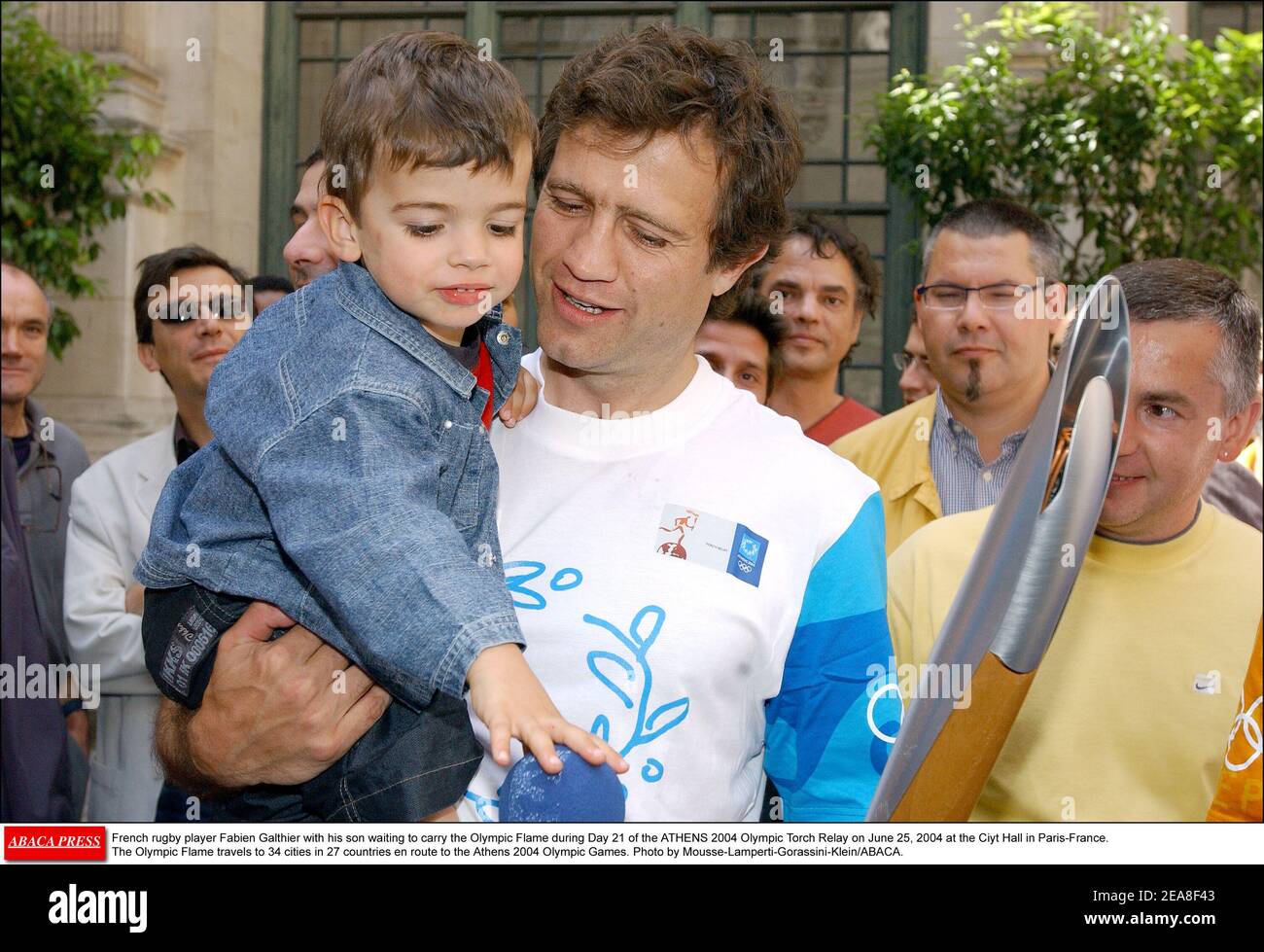 French rugby player Fabien Galthie with his son waiting to carry the ...