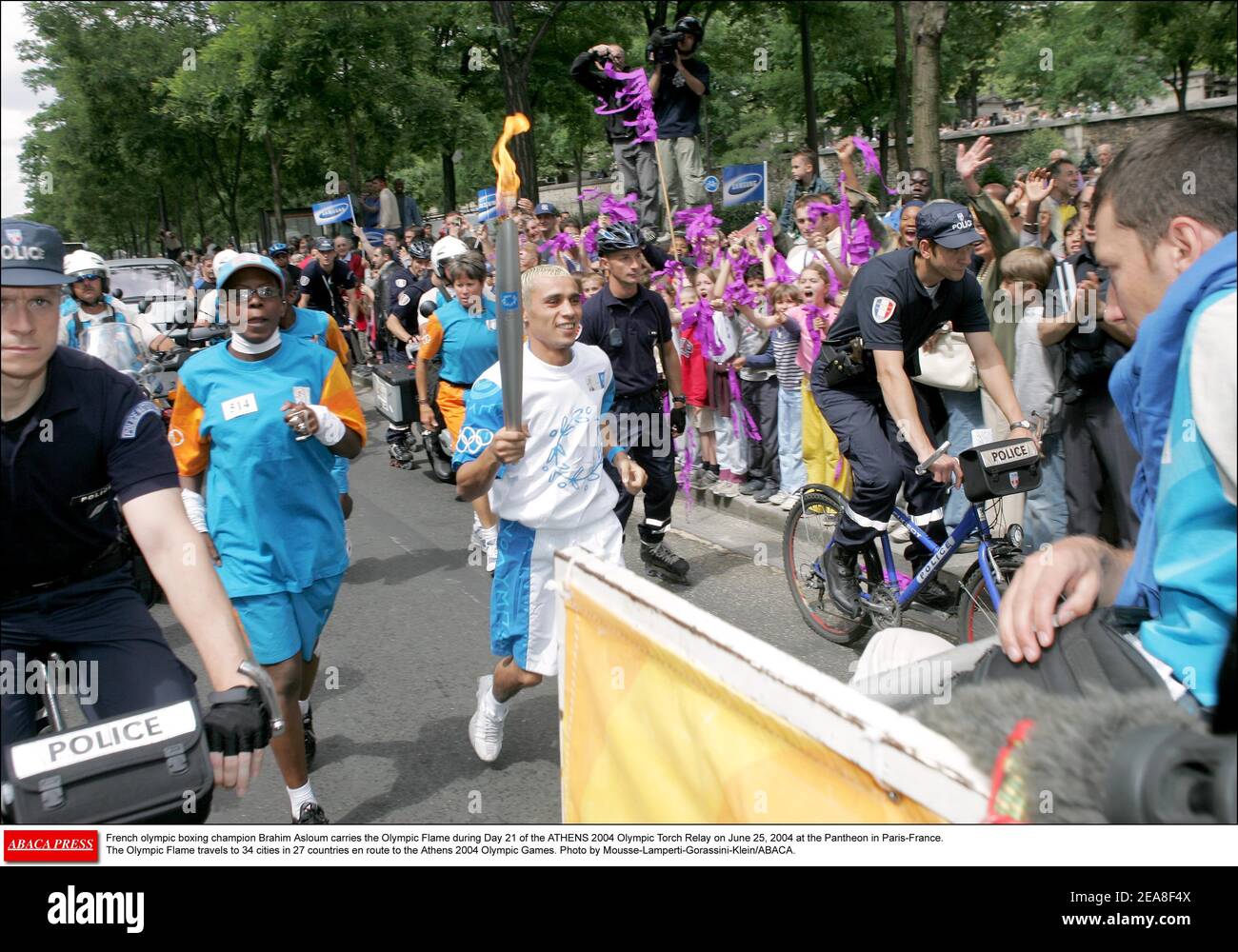 French olympic boxing champion Brahim Asloum carries the Olympic Flame ...