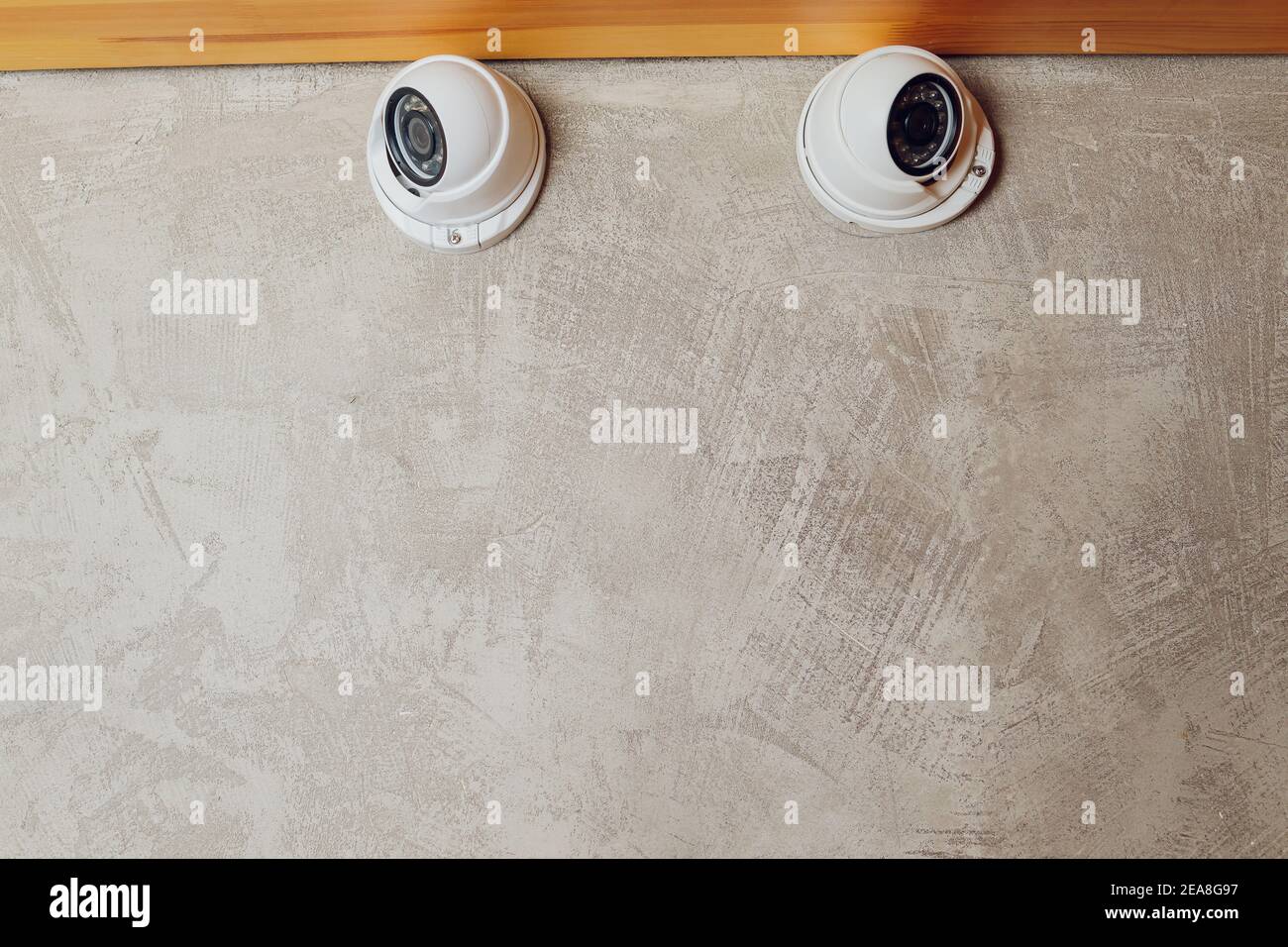 Two security camera s on a wall Stock Photo - Alamy