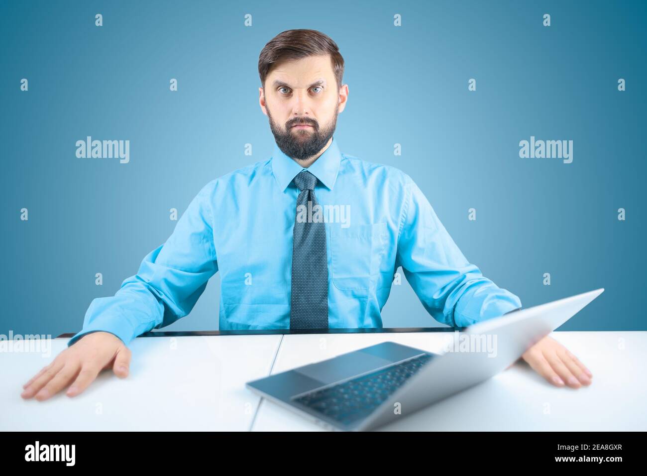 a businessman in a shirt and tie sits at a computer Stock Photo - Alamy