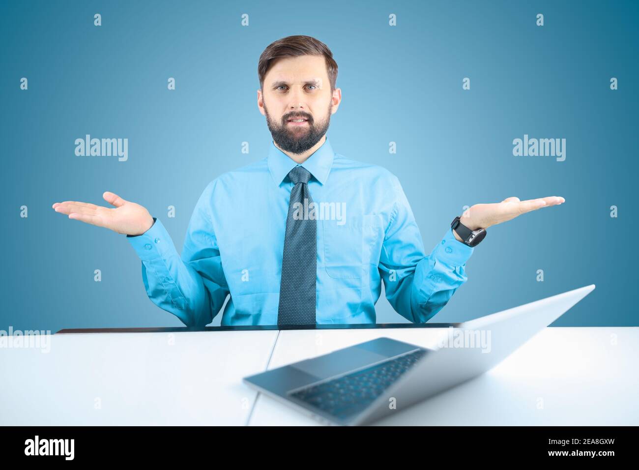 a businessman in a shirt and tie sits at a computer Stock Photo - Alamy