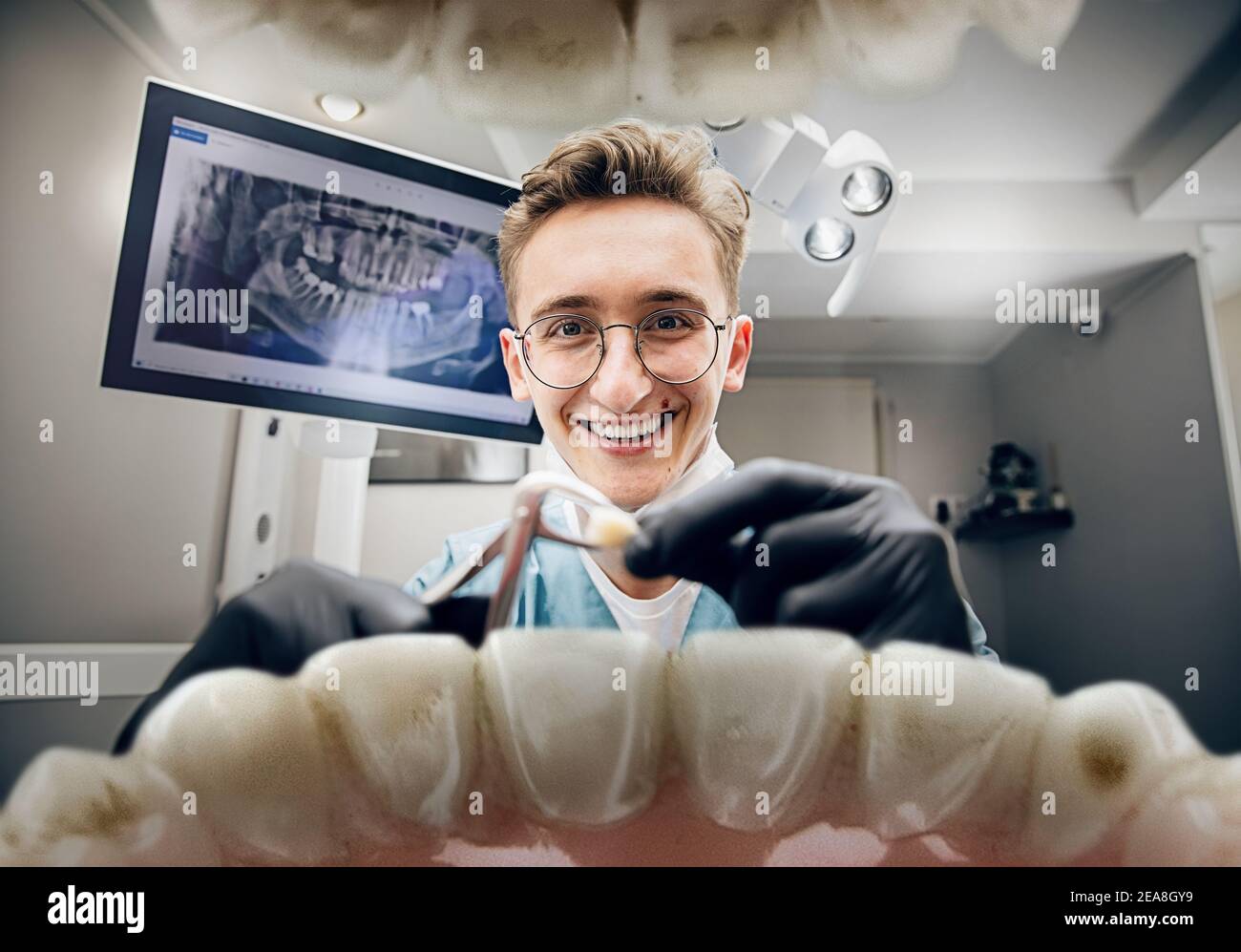 Holding teeth. Doctor looking into mouth, checking, examining teeth ...