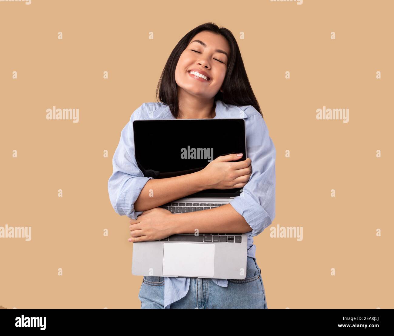 Technology Lover. Excited asian woman hugging personal computer Stock ...