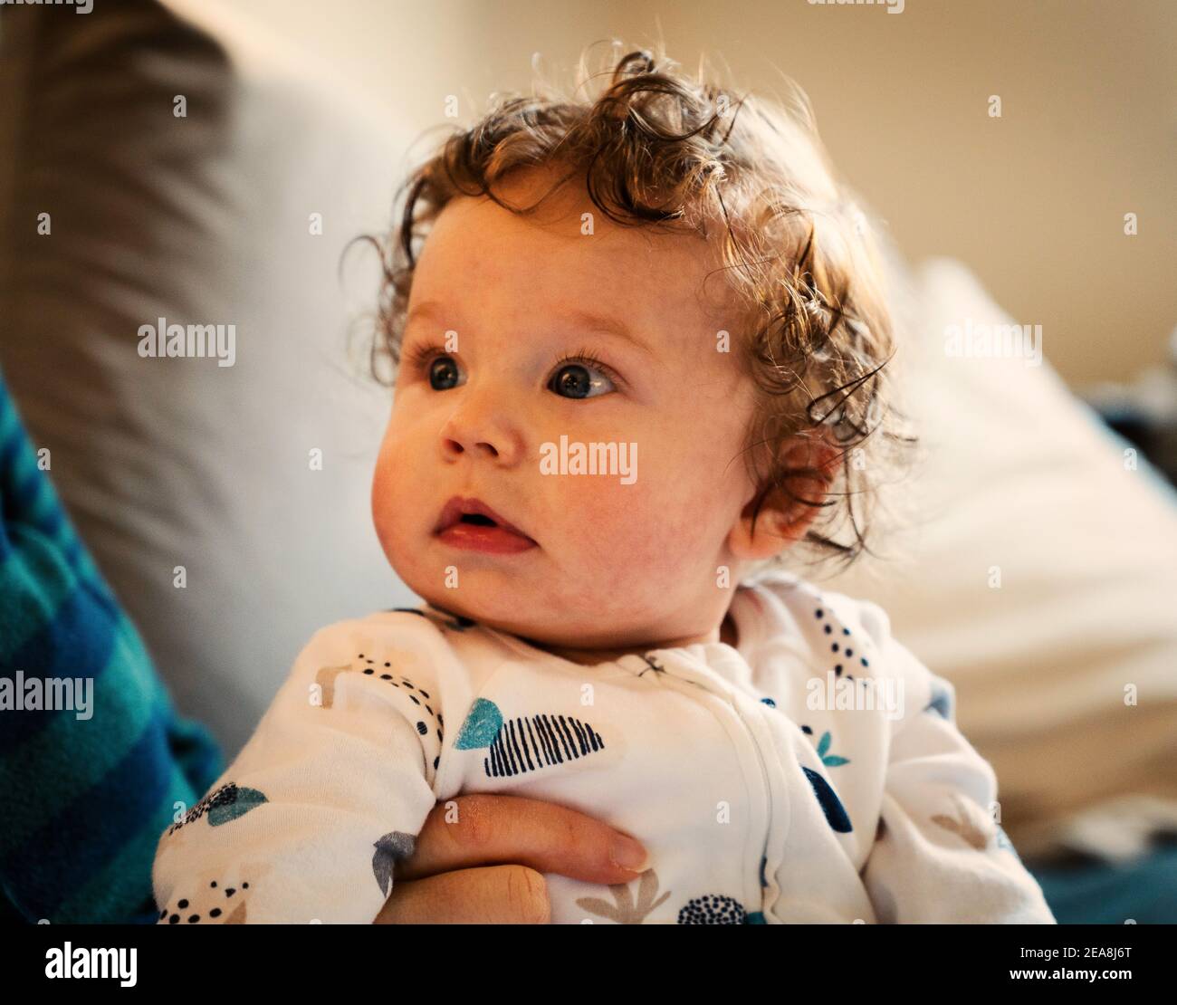 Babby boy sitting upright with help from Mum Stock Photo - Alamy