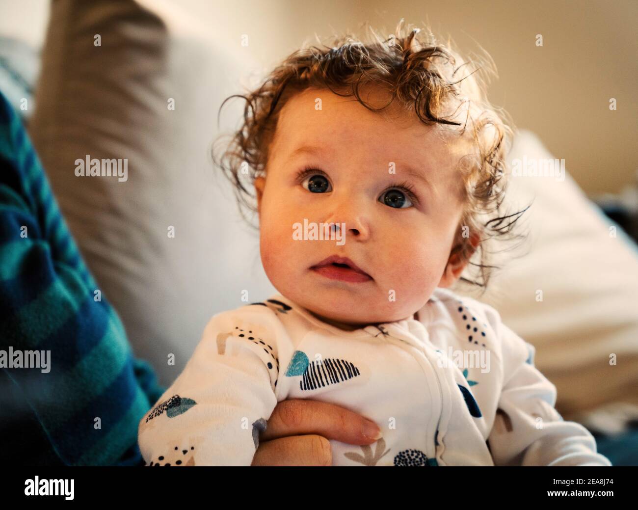 Babby boy sitting upright with help from Mum Stock Photo - Alamy
