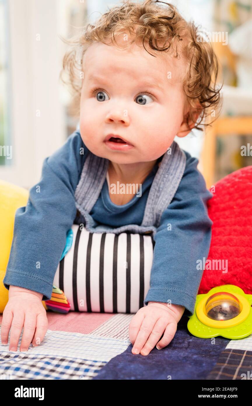 Baby boy using tummy roller Stock Photo - Alamy