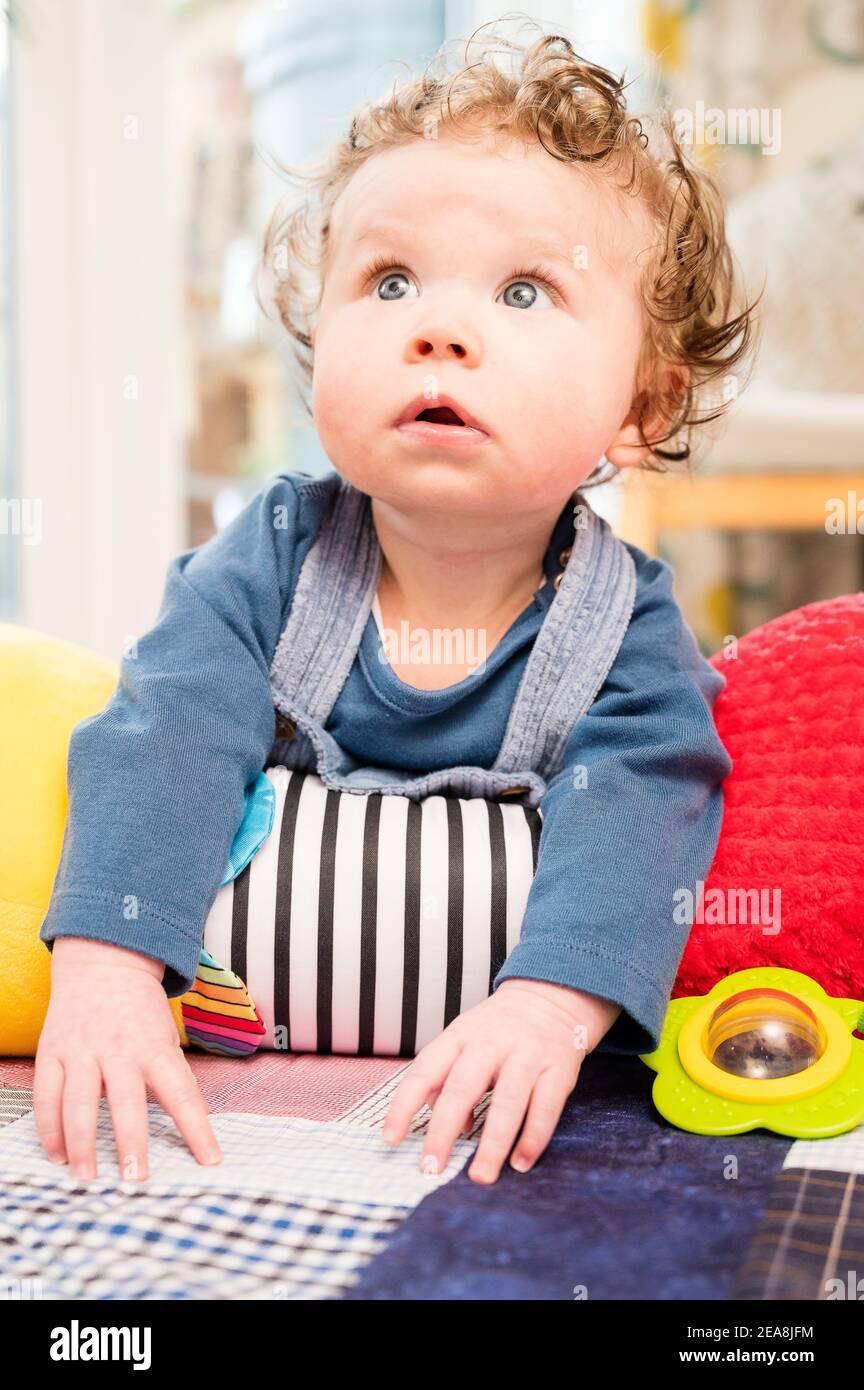 Baby boy using tummy roller Stock Photo - Alamy