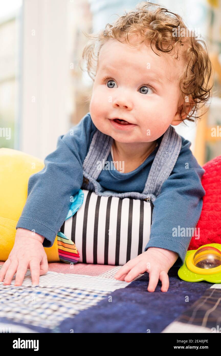 Baby boy using tummy roller Stock Photo - Alamy