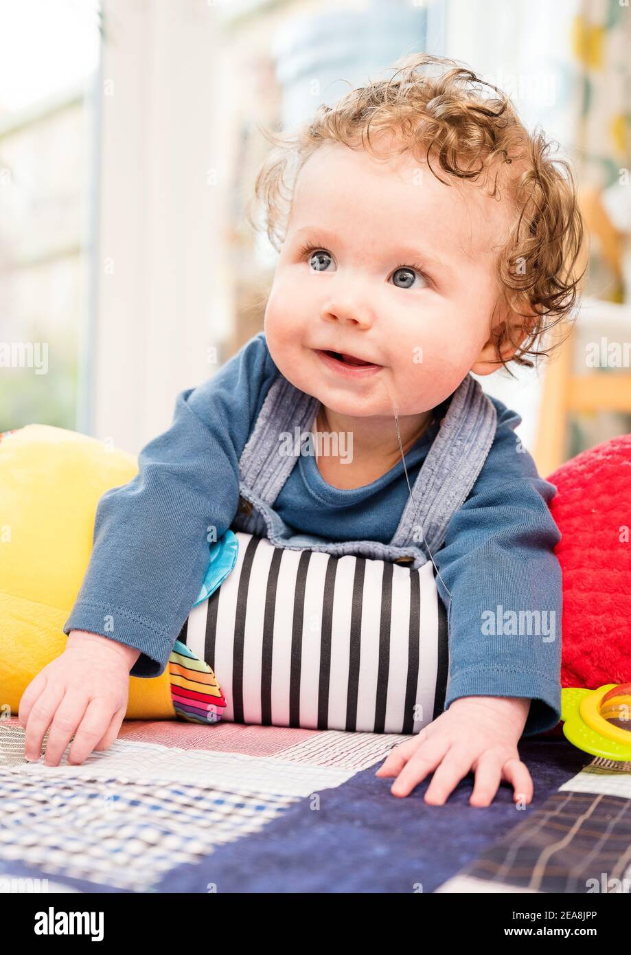 Baby boy using tummy roller Stock Photo - Alamy