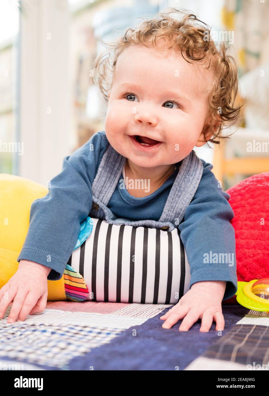 Baby boy using tummy roller Stock Photo - Alamy