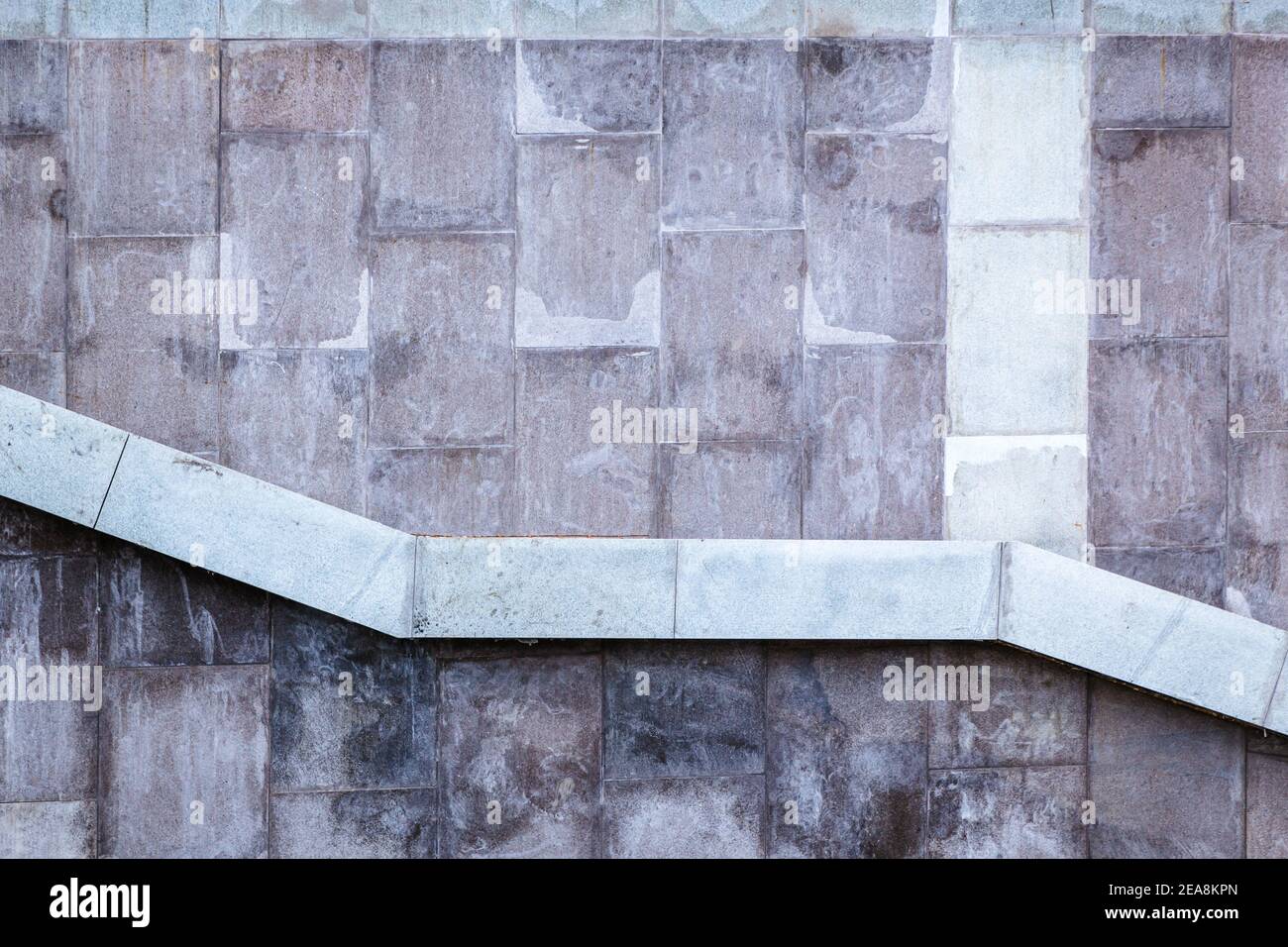 Strange wall lined with concrete slabs background Stock Photo - Alamy