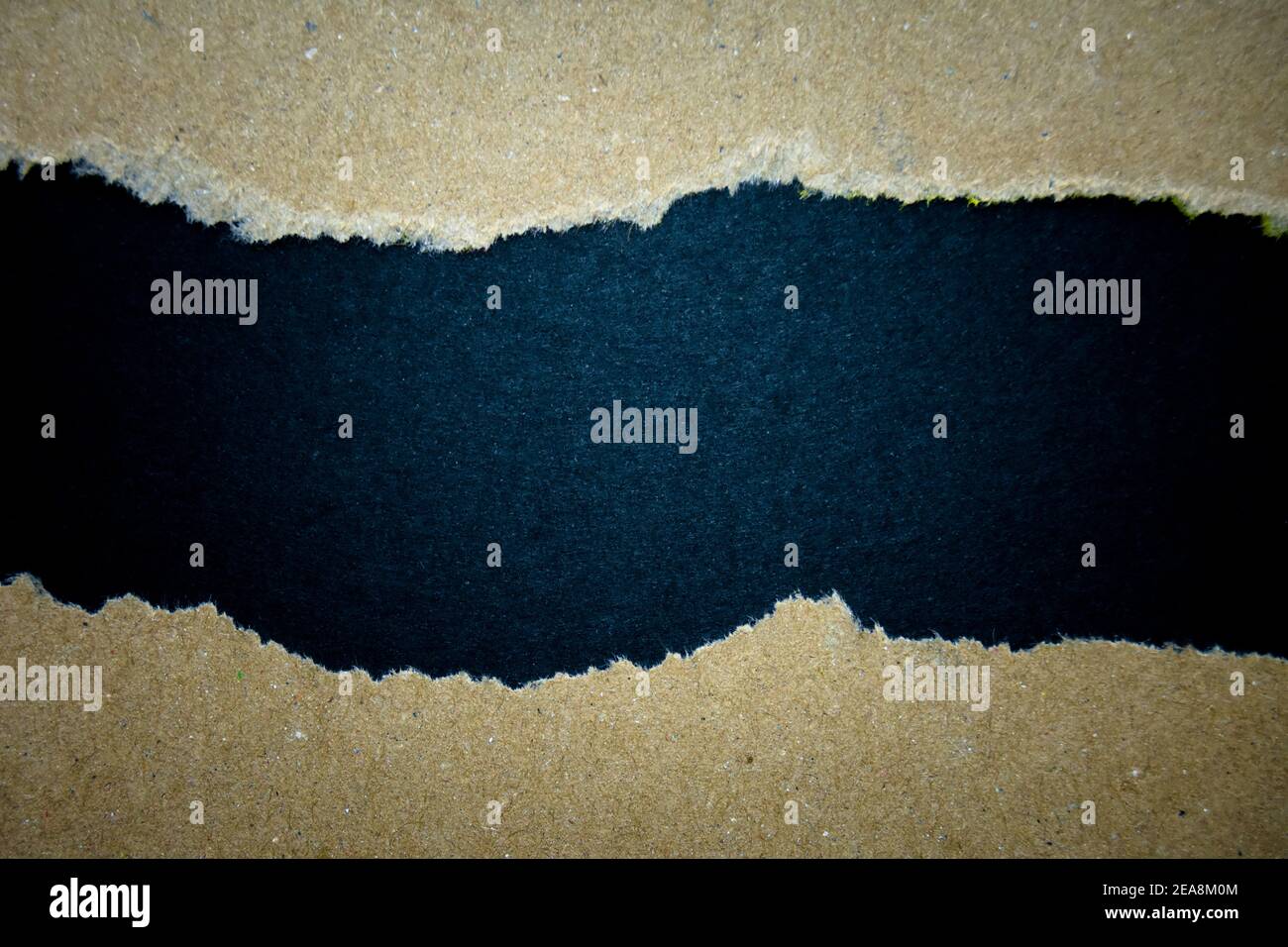 Ripped brown paper on black background, space for copy Stock Photo - Alamy
