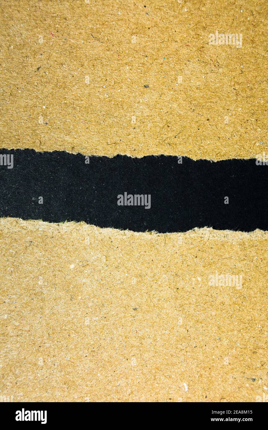 Ripped brown paper on black background, space for copy Stock Photo - Alamy