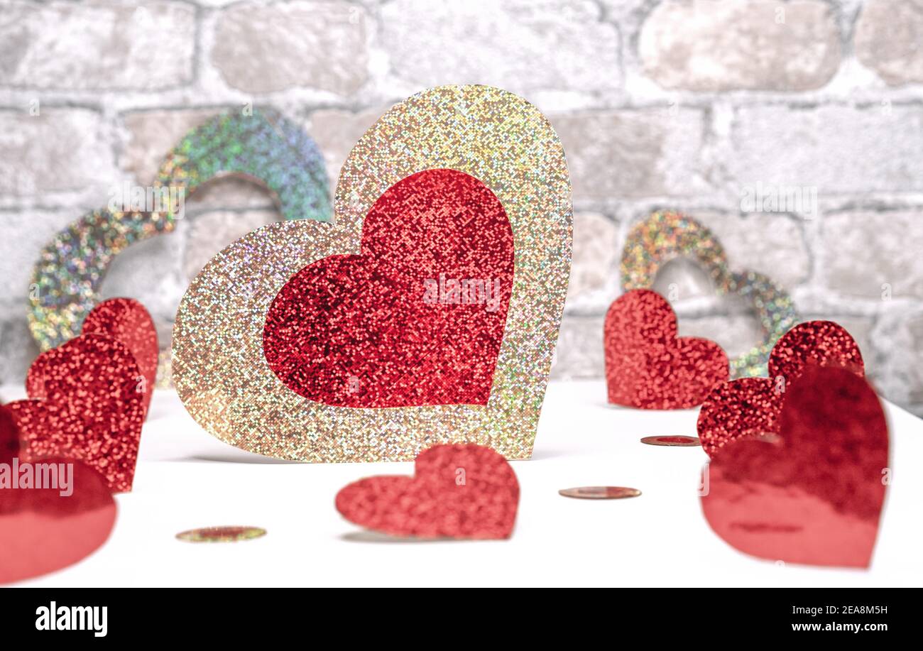 Red-gold shiny hearts on a brick wall background. Valentine's Day ...