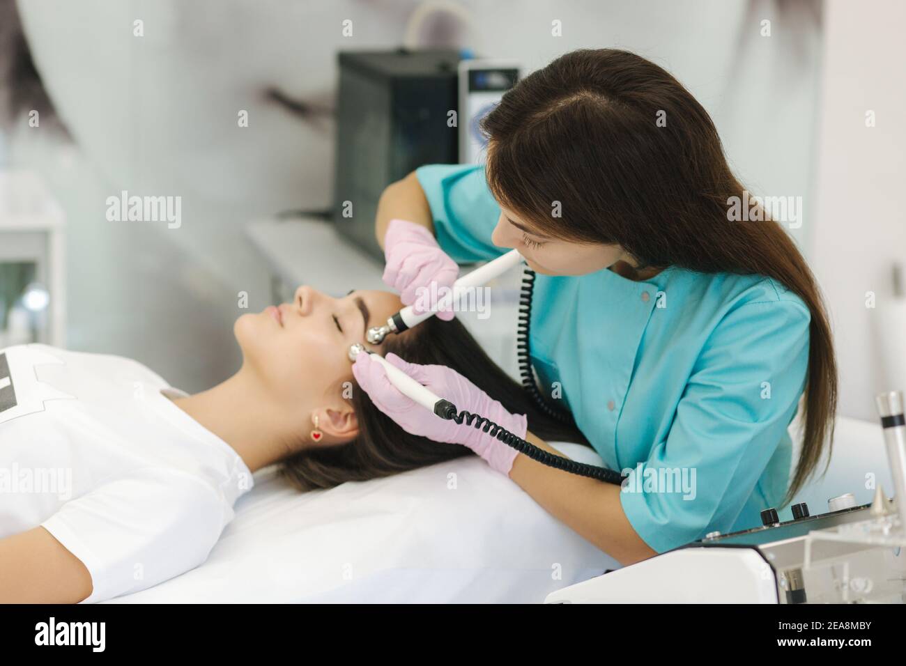 Young woman taking beauty procedure in spa salon Stock Photo - Alamy