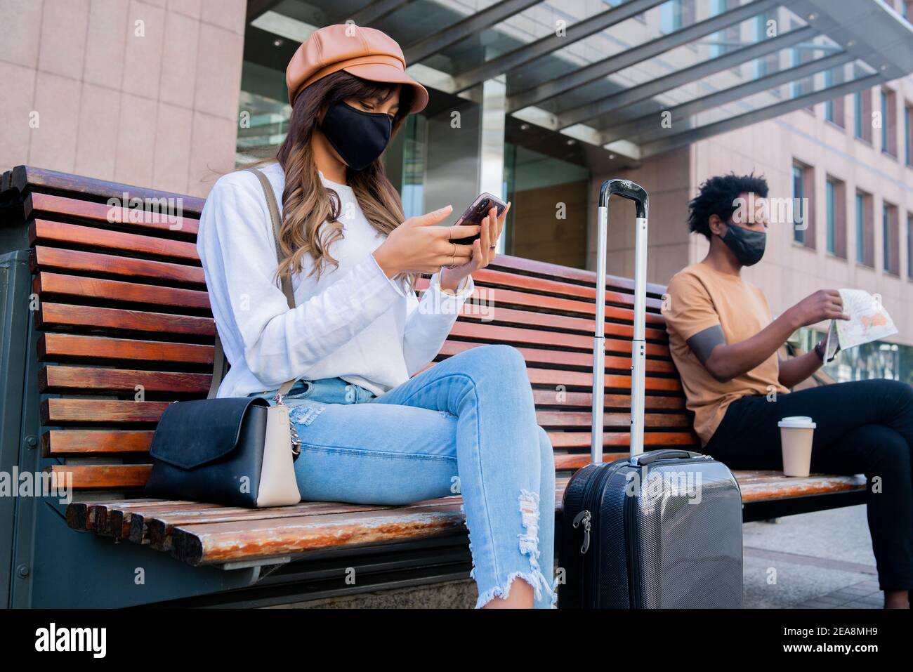Tourist people waiting outside airport or train station Stock Photo - Alamy