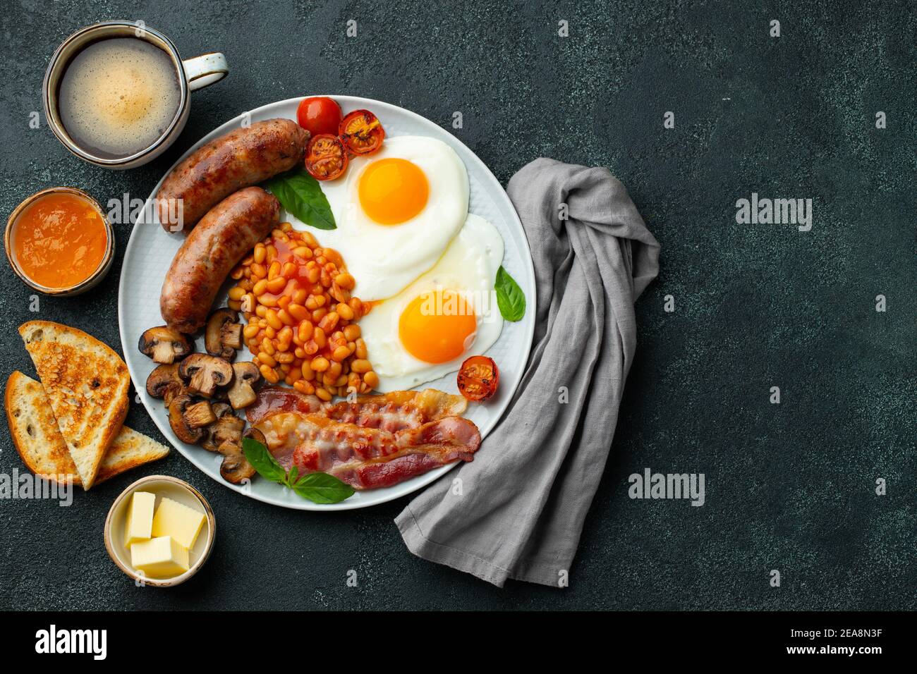 Full English breakfast on a plate with fried eggs, sausages, bacon ...