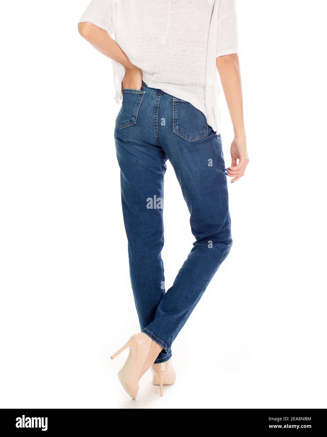 Feet of a woman standing on white background with blue jean Stock Photo ...