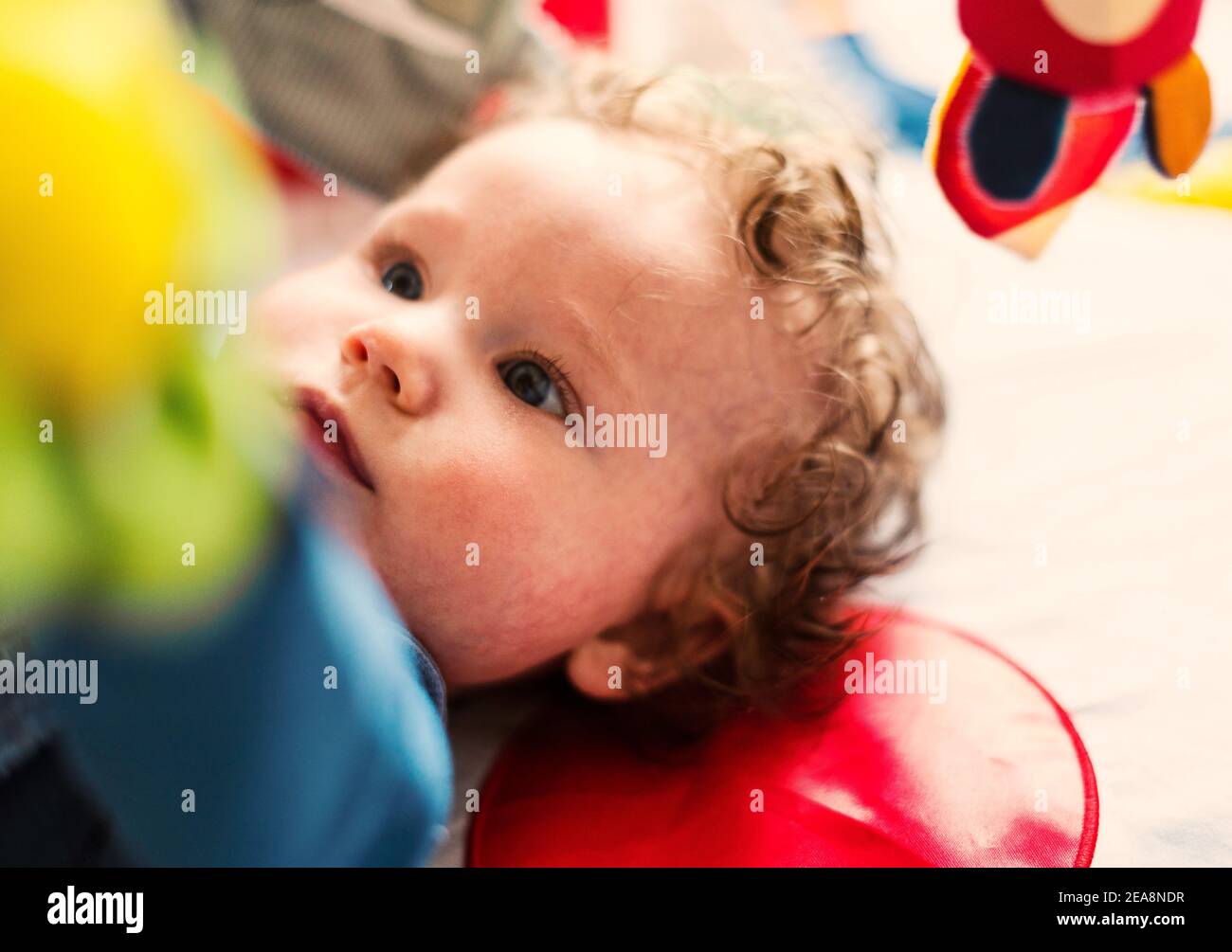 Baby boy exploring mobile toys Stock Photo - Alamy