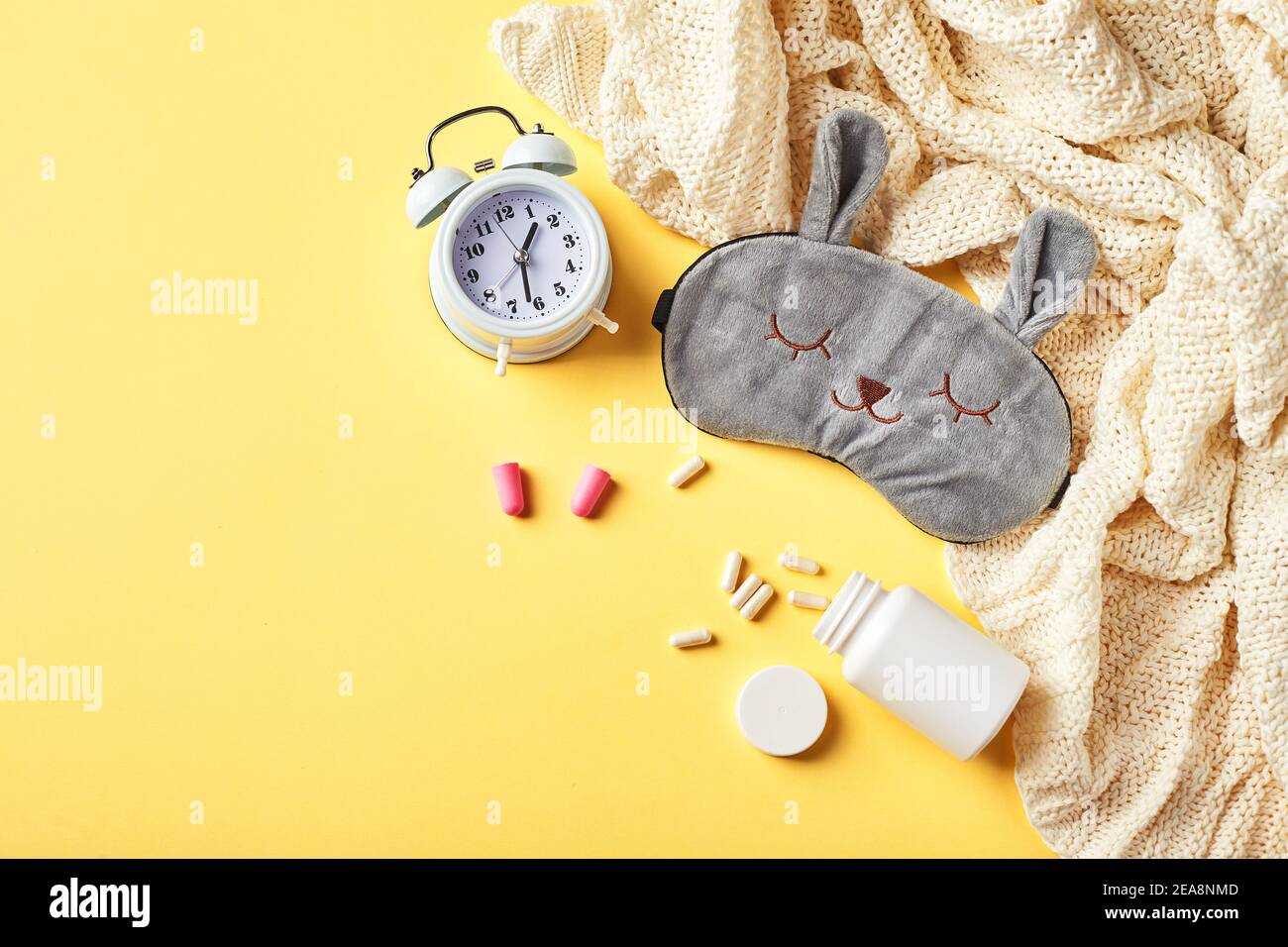 Sleeping mask, alarm clock, earplugs and pills. Healthy night sleep ...