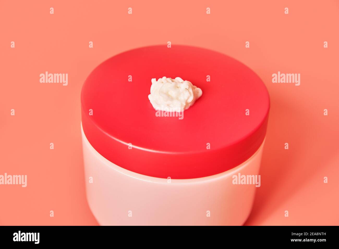 pink jar with drop of cream on the lid Stock Photo - Alamy