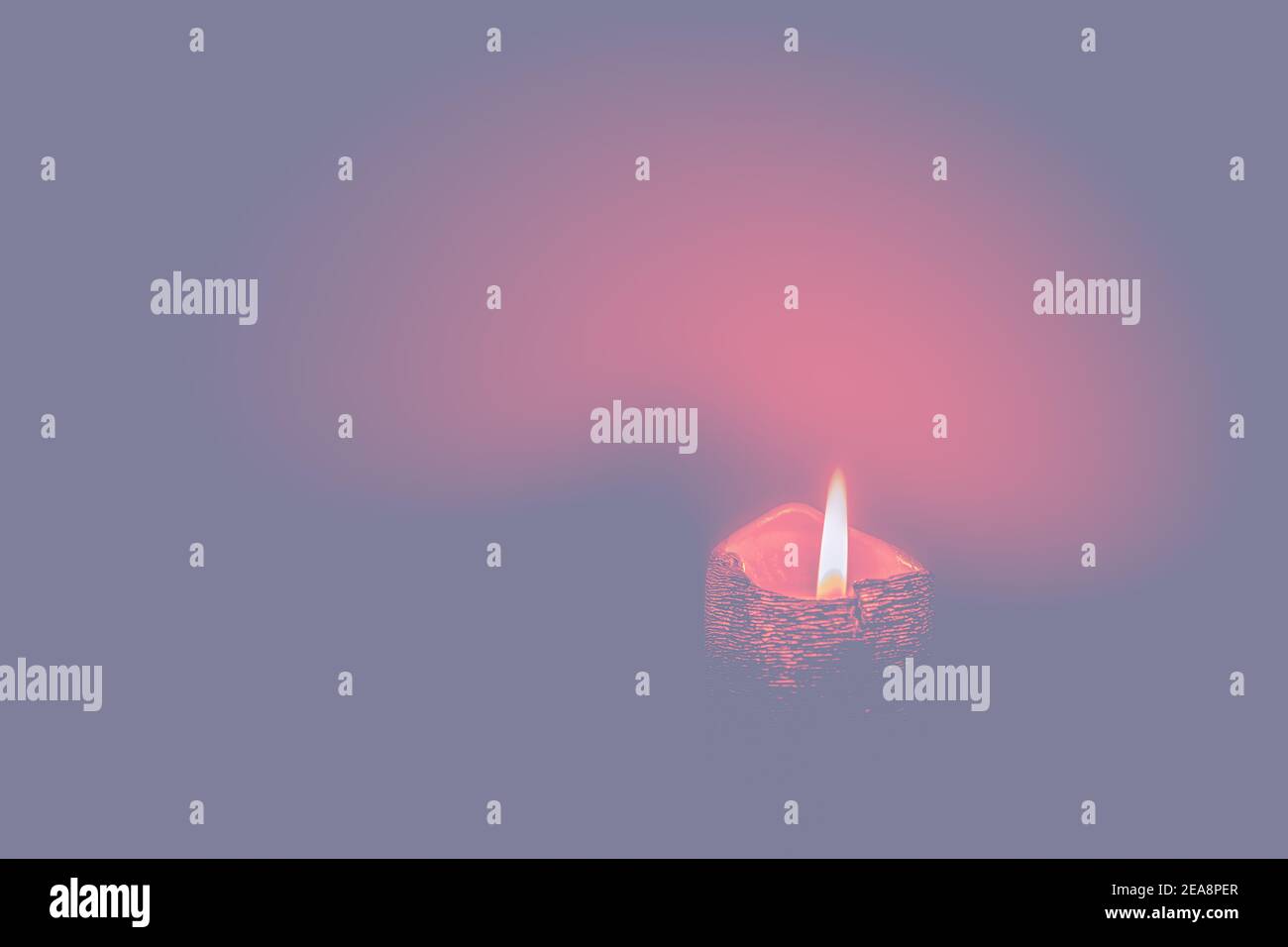 Red candle burning on misty pastel tones background. Candlelight in ...