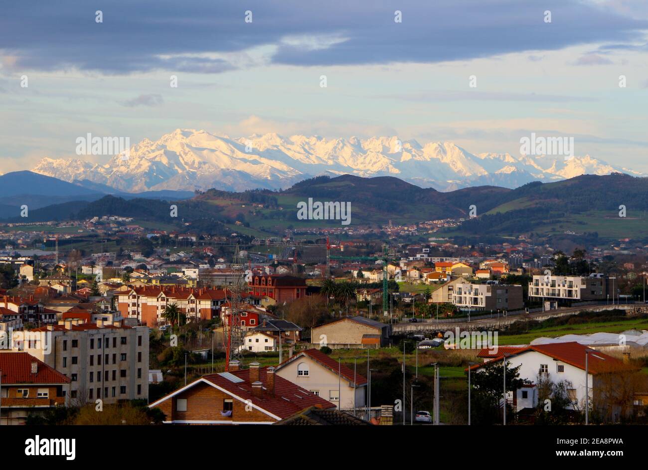 Snow covered mountains in the distance with urban landscape in ...