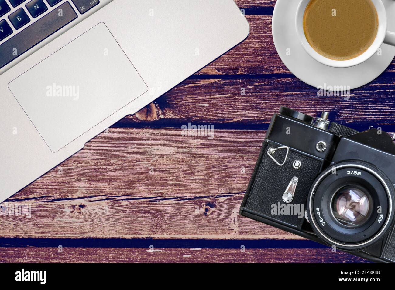 An office table, computer and an old camera Stock Photo - Alamy
