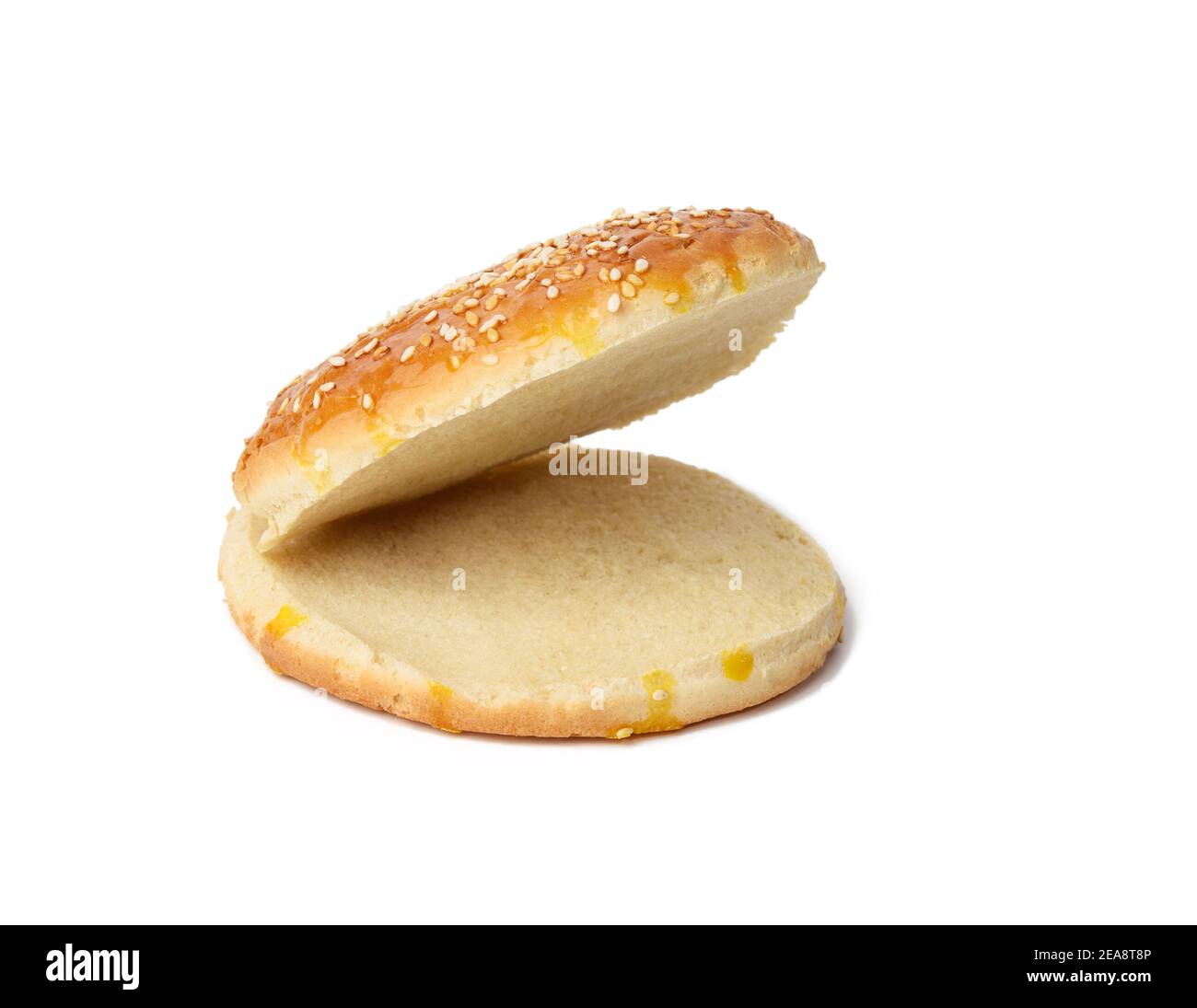 baked sesame seed round bun for burger, bun cut in half, close up Stock ...