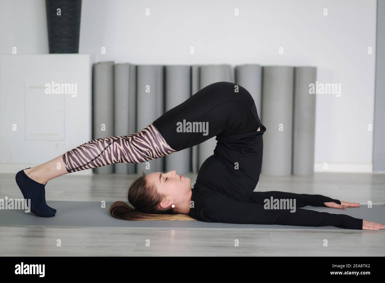 Young stretching master show differnt poses for stretch Stock Photo - Alamy