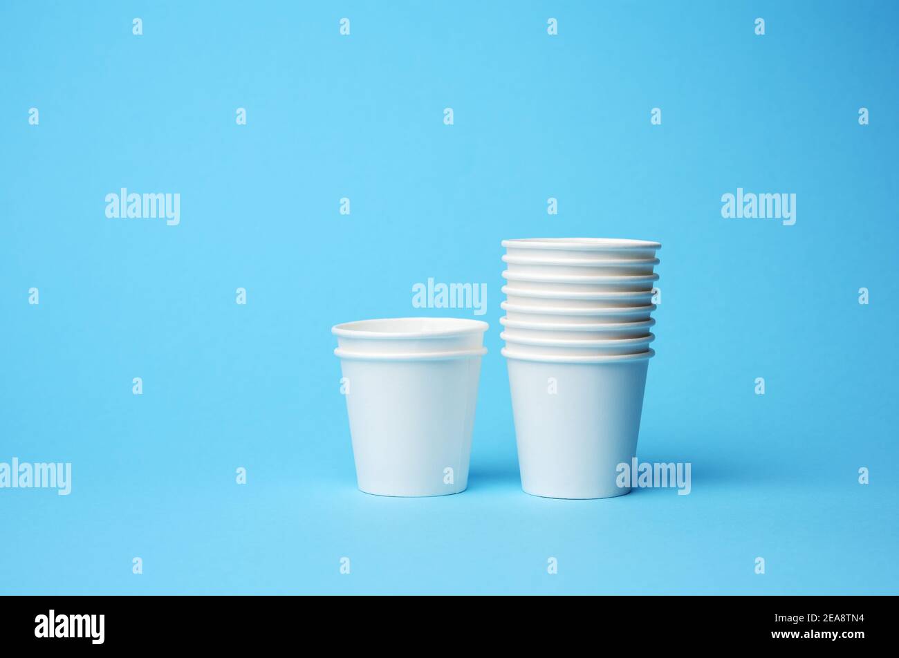 a stack of white paper cups on a blue background. Plastic rejection ...