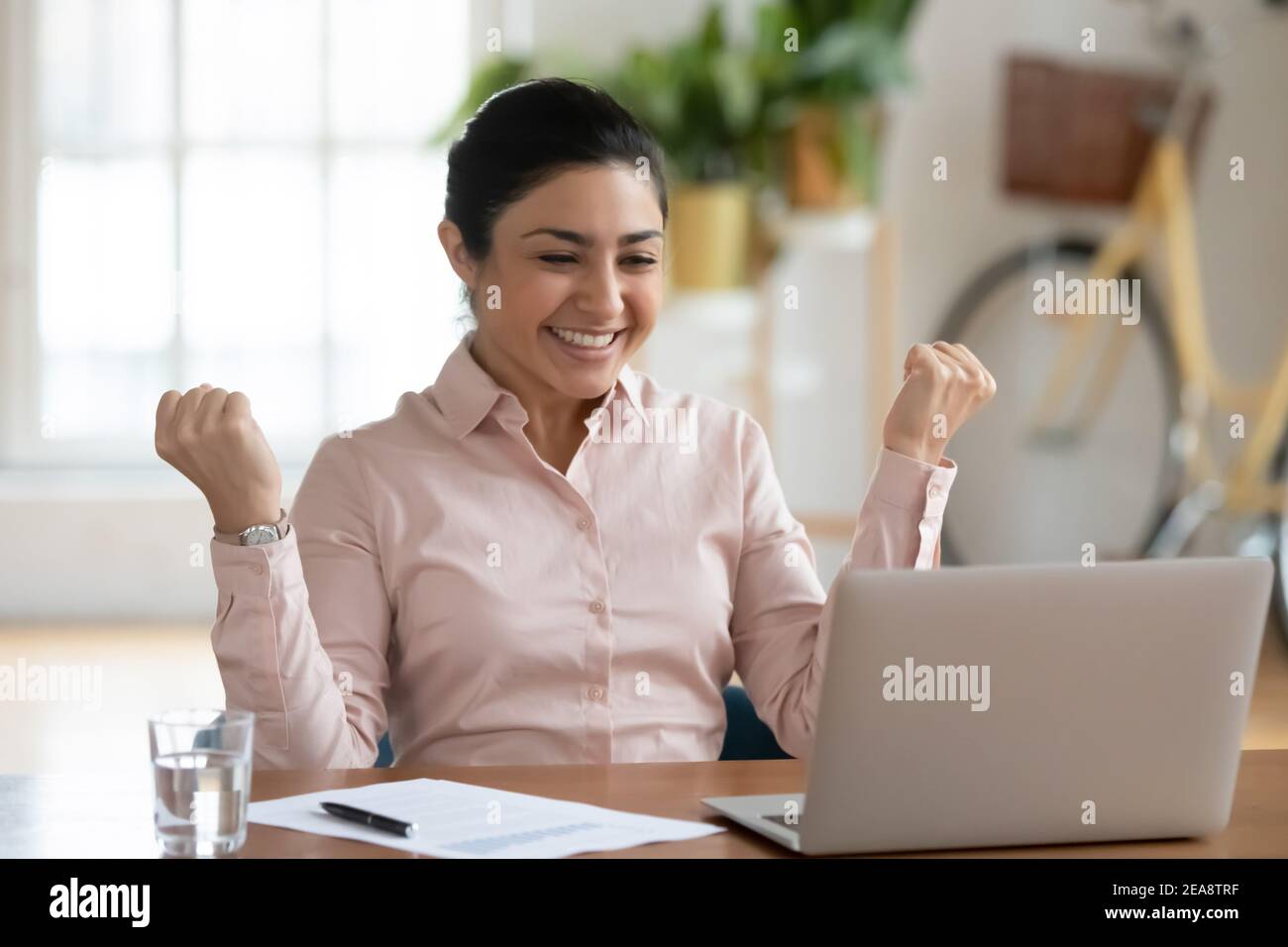 Happy professional celebrating success and making winner gesture Stock ...