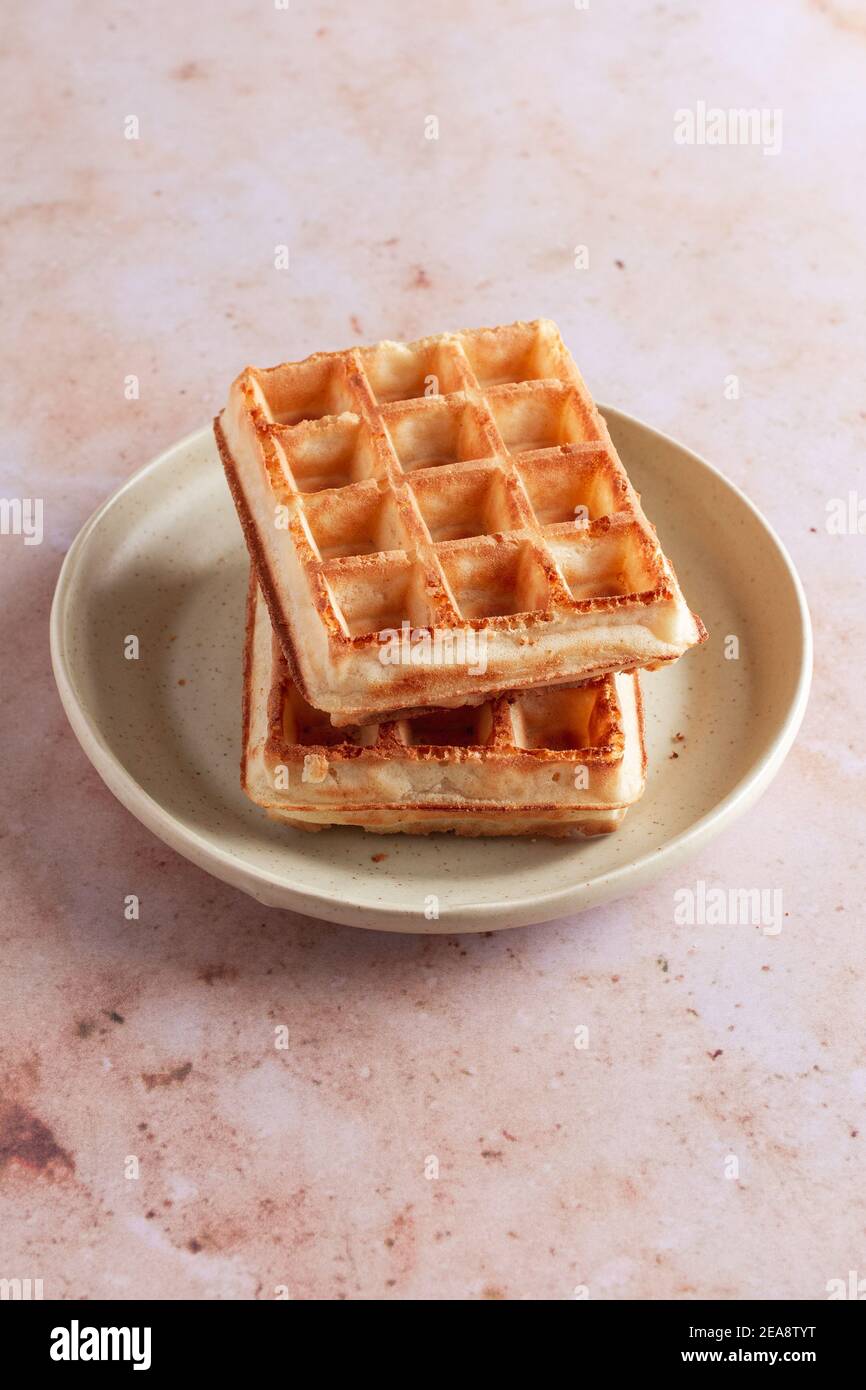 Stack of two plain Belgian waffles on a small plate Stock Photo - Alamy