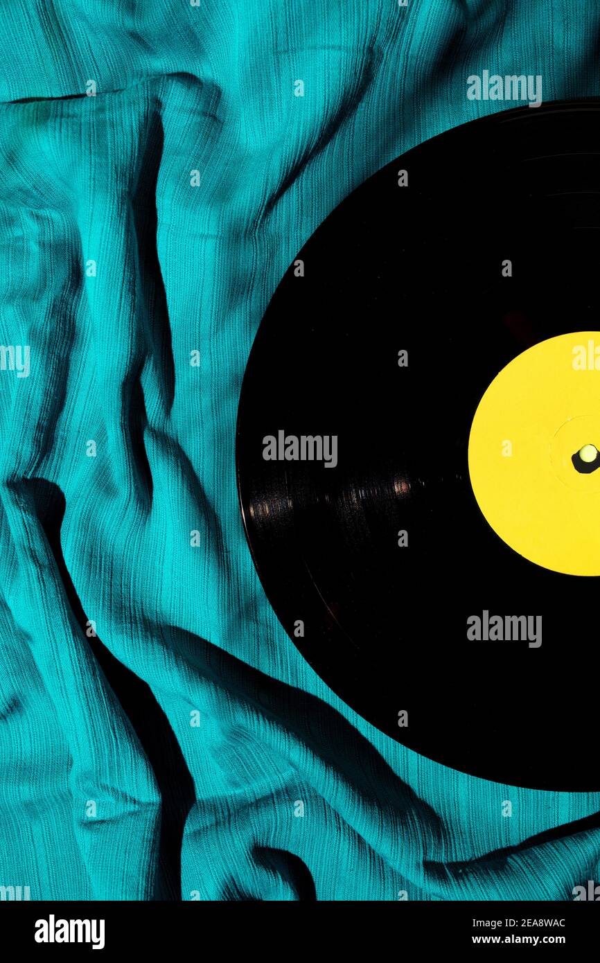 Layout of LP vinyl record on a cyan silk or saten fabric. Old vintage ...