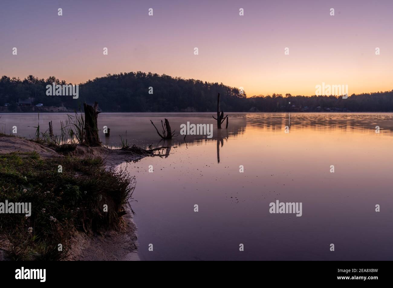Early sun over the lake. Purple sky and purple lake. Purple sunrise ...