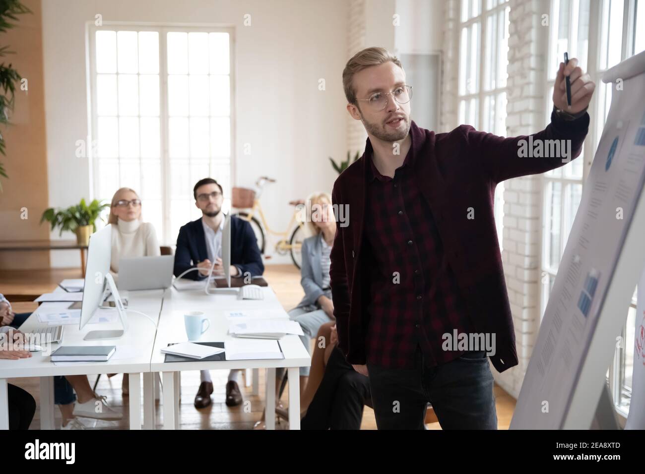 Startup leader presenting charts to his team in meeting room Stock ...