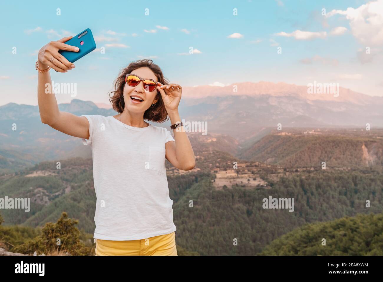 female travel blogger and social media influencer takes photos against ...