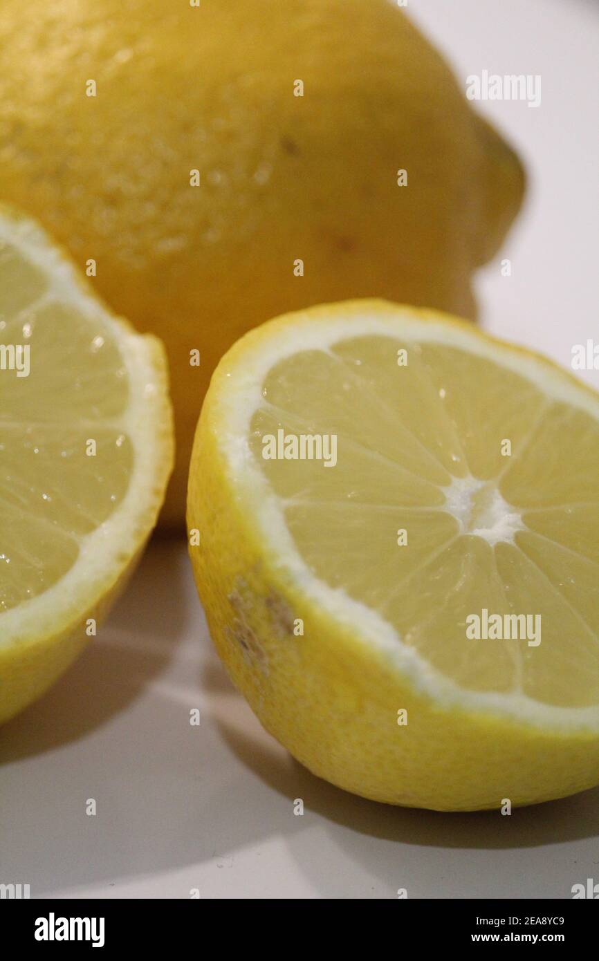 Vertical closeup shot of a sliced lemon and a whole lemon Stock Photo ...