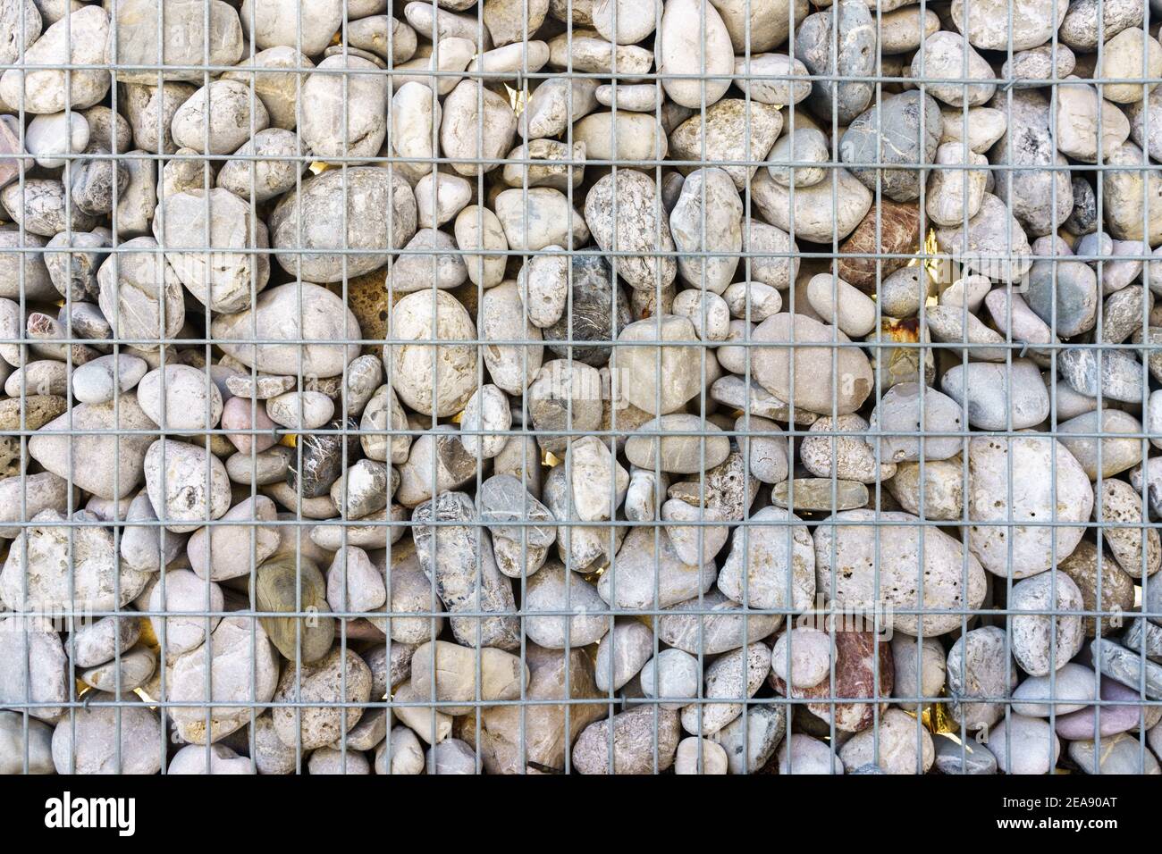 Texture background stones under the metal grid. Natural pattern Stock ...
