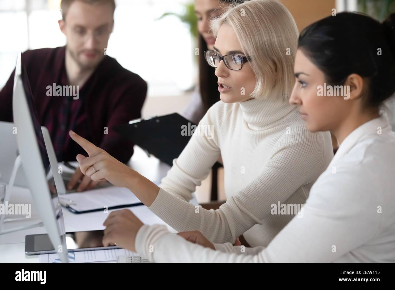 Manager showing work application, explaining task or project Stock ...