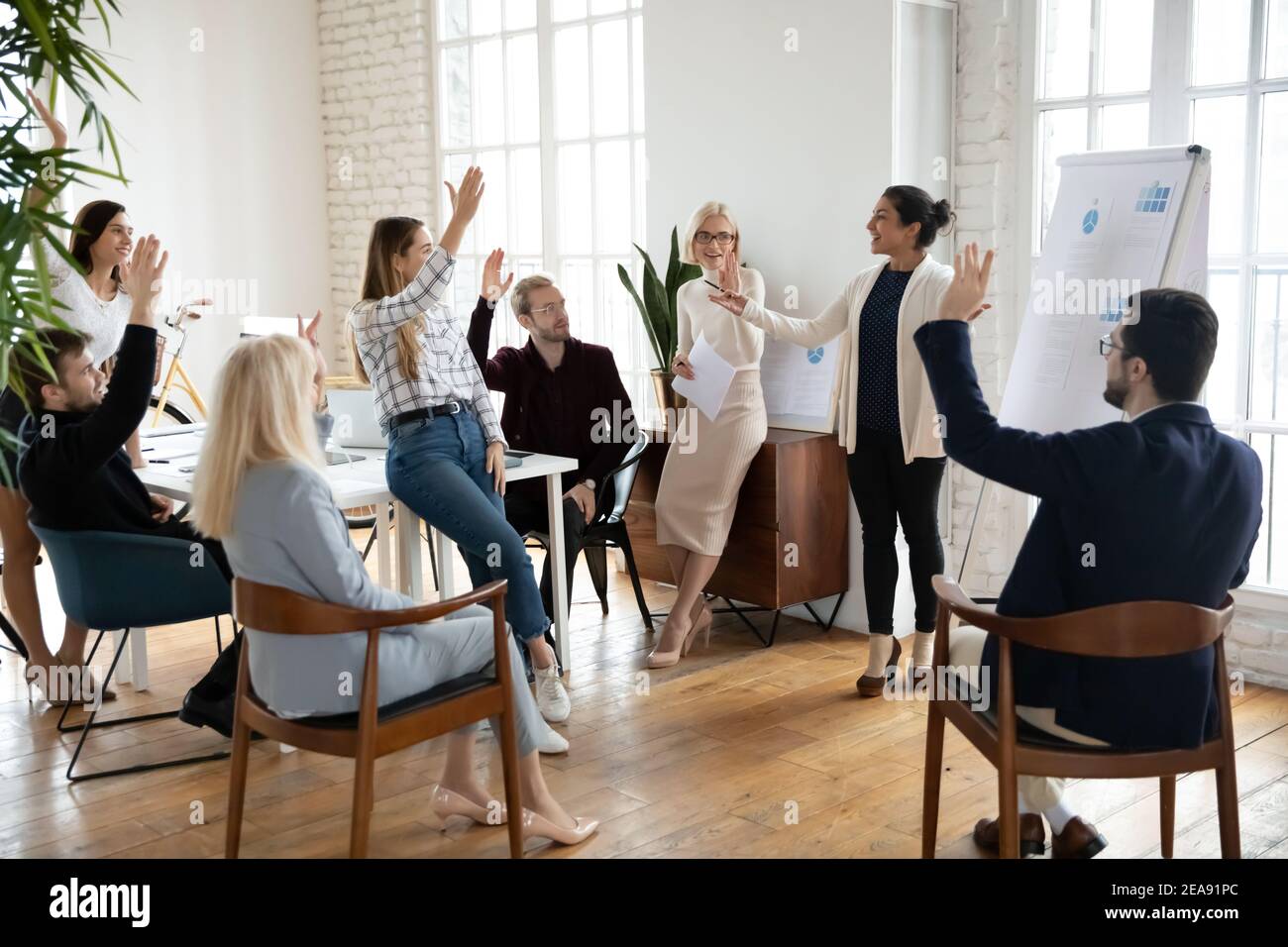 Female raising hand vote seminar hi-res stock photography and images ...