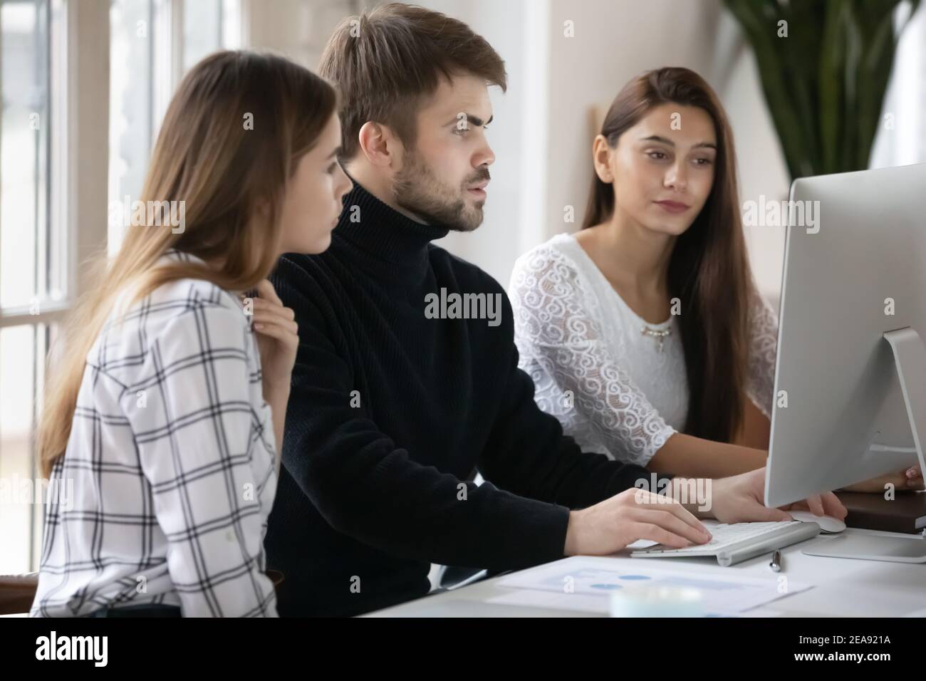 Group of business people working at computer together Stock Photo - Alamy