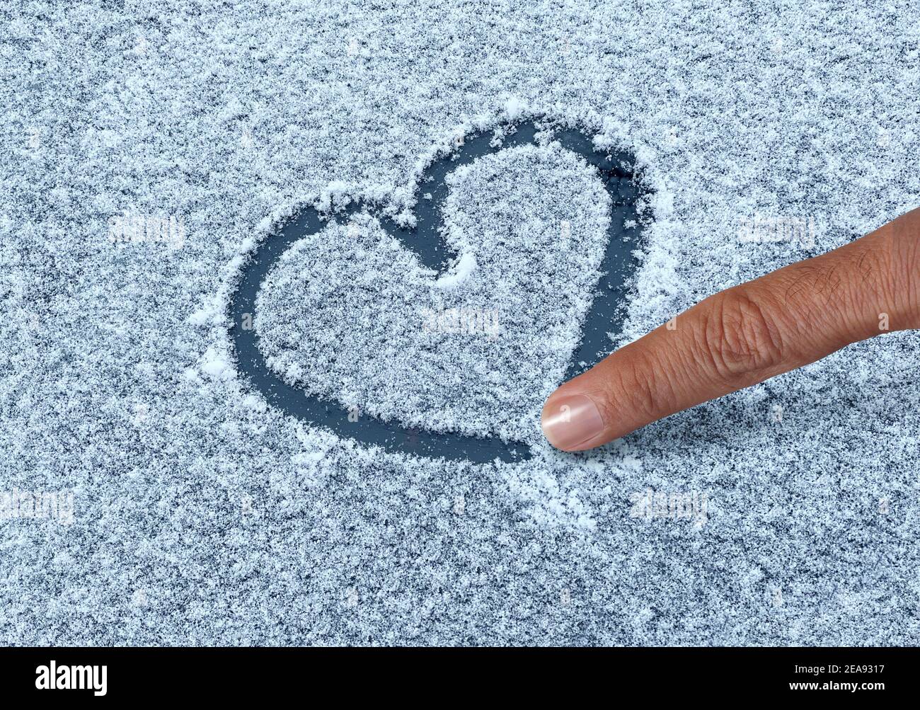 Drawing a snow heart with a finger as a fun winter love symbol as a ...
