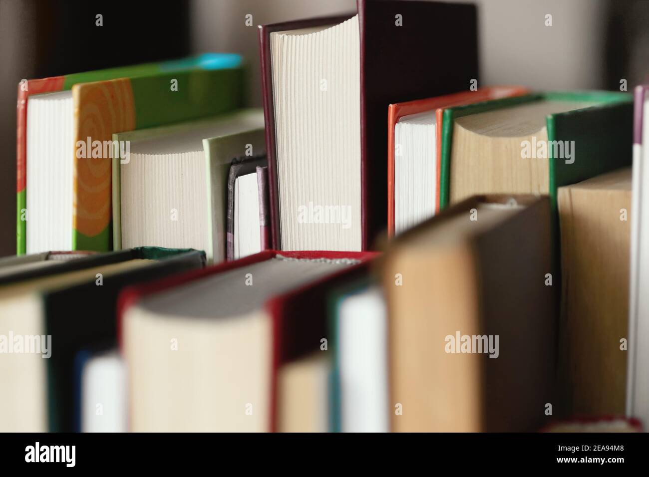 This is a lot of books standing together in several rows. Solid ...