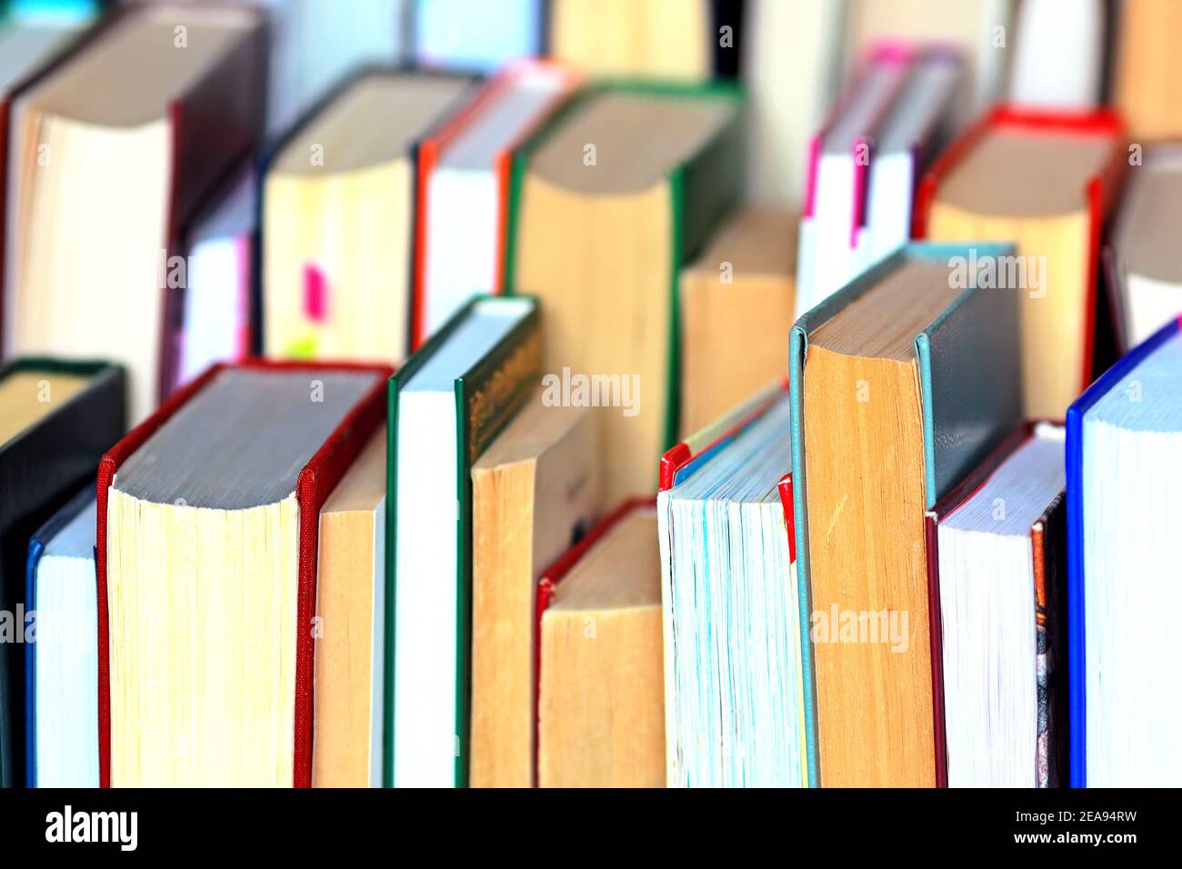 This is a lot of books standing together in several rows. Solid ...