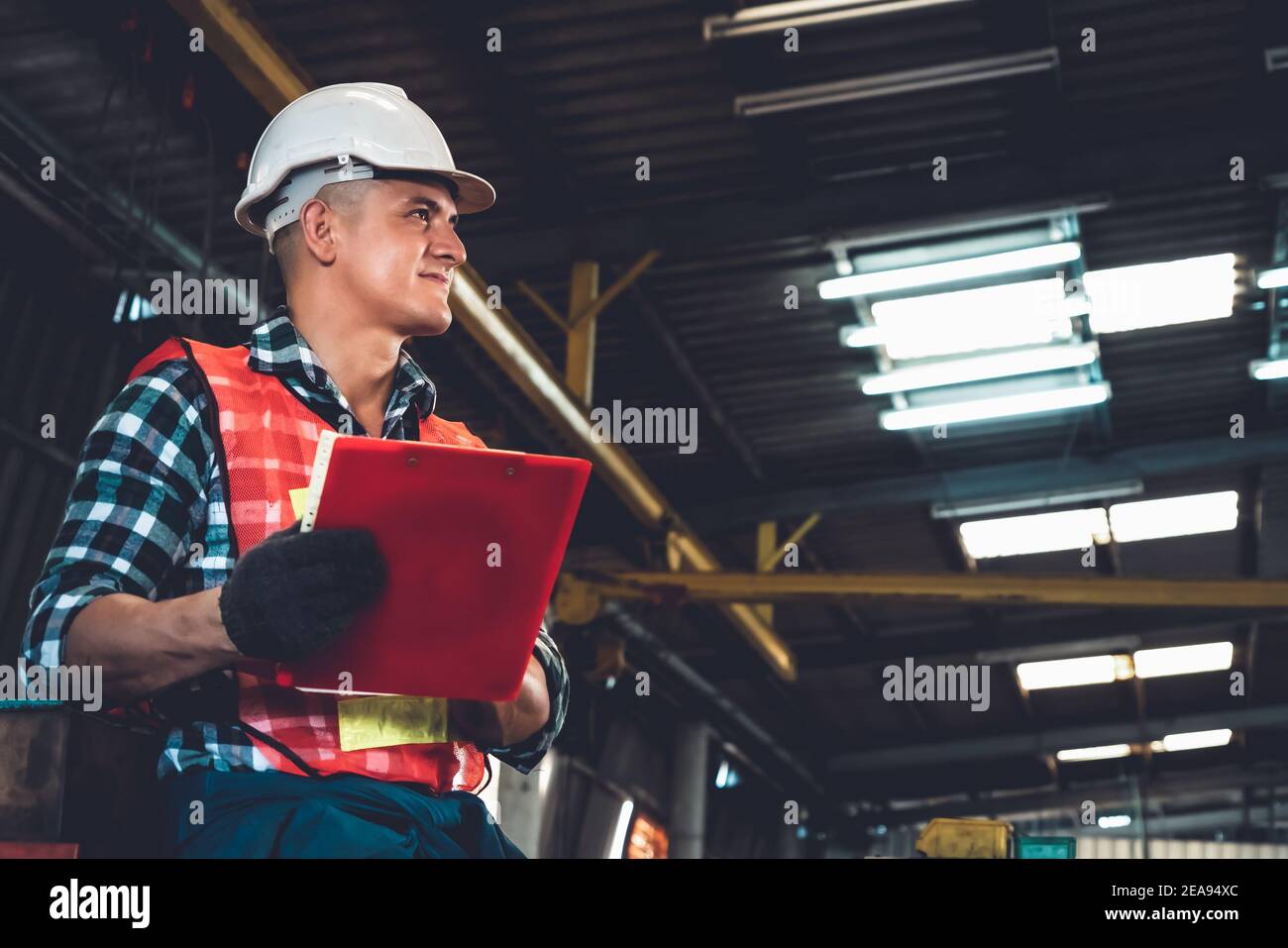 Manufacturing worker working with clipboard to do job procedure ...